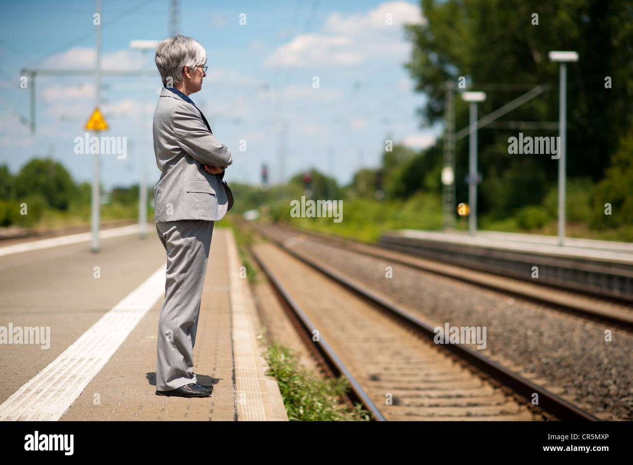 Woman, 50 +, waiting at a deserted platform Stock Photo - Alamy