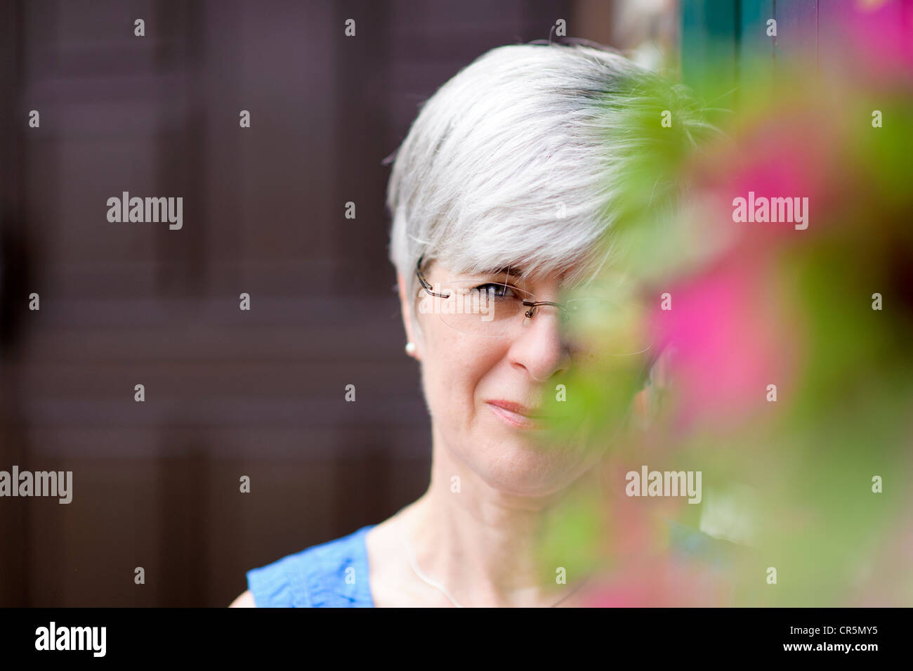 Woman behind bush hi-res stock photography and images - Alamy