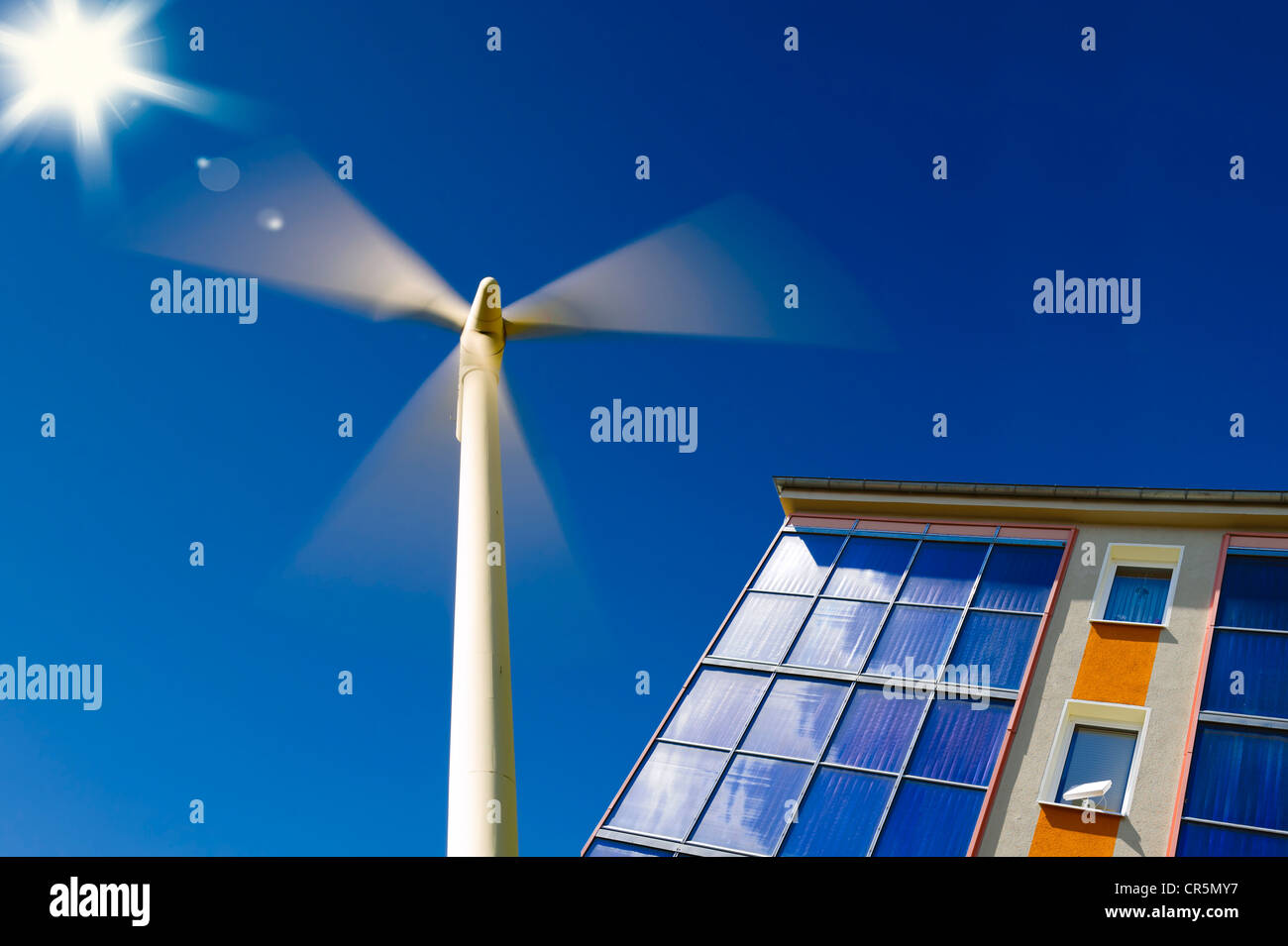 Wind turbine and residential building with solar panel Stock Photo - Alamy