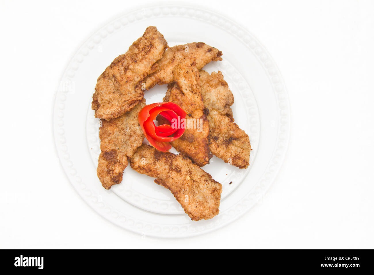 Fried Fish Fillet decorated with tomato pealing Stock Photo - Alamy