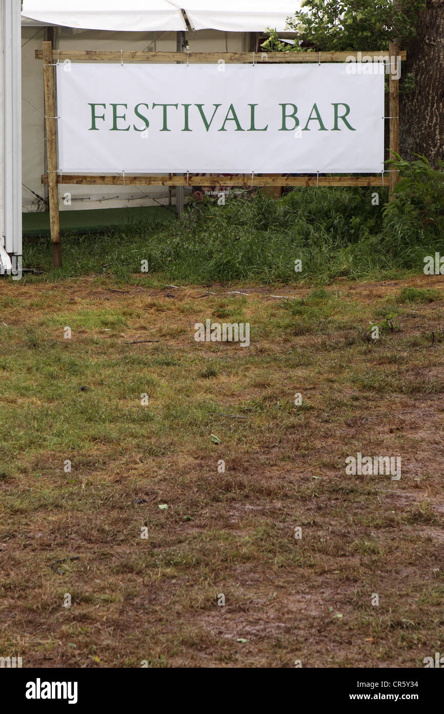 Festival Bar sign at wet muddy outdoor festival Stock Photo - Alamy