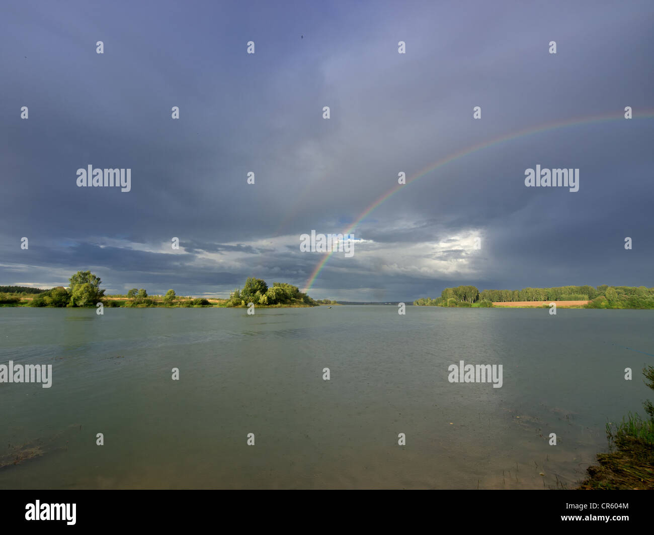 Summer landscape with two rainbows over lake. Ruzskoe lake in Russia ...