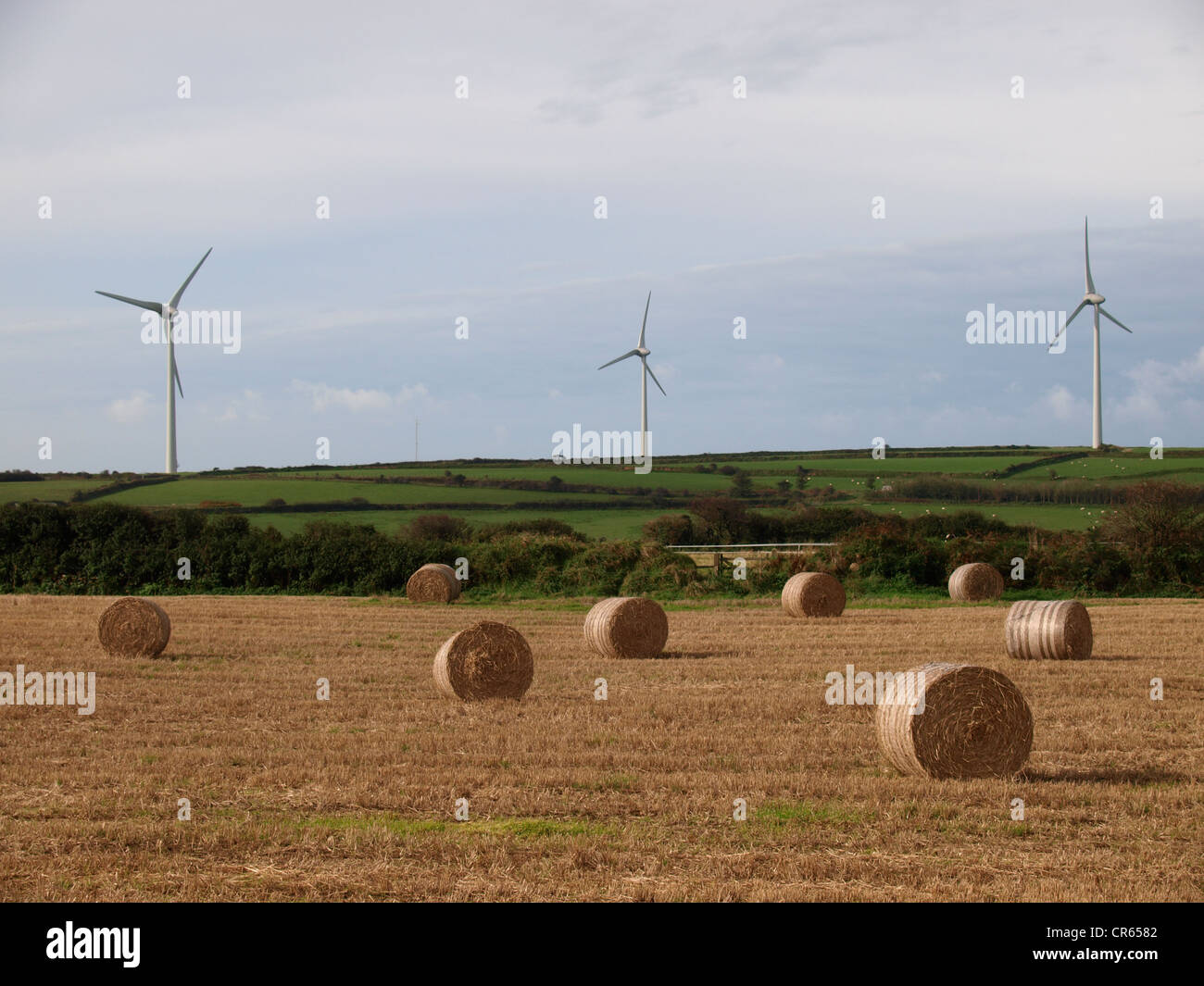 Round hay bales and wind turbines, Cornwall, UK Stock Photo - Alamy