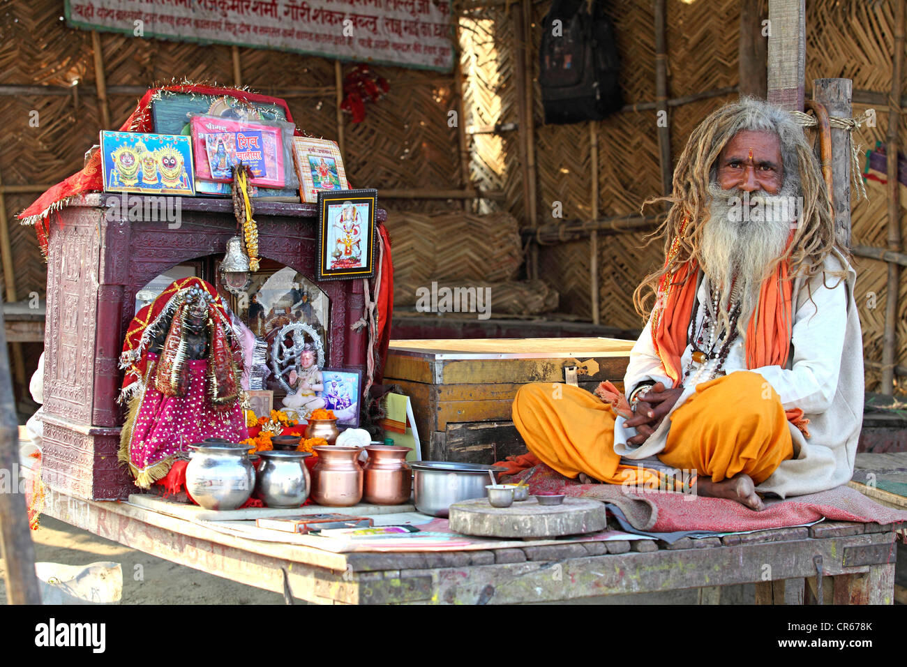 Sadhu, an Indian wandering holy man, sitting alongside the Ganges River ...
