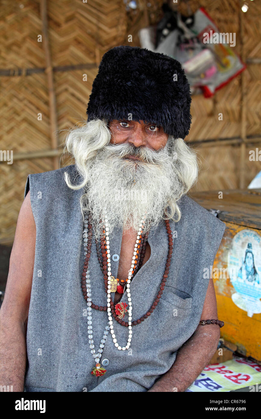 Sadhu, an Indian wandering holy man, sitting alongside the Ganges River ...