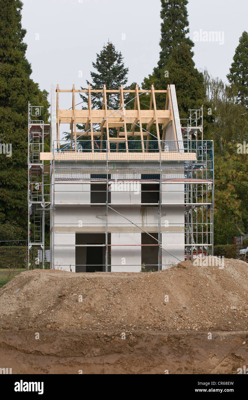 Building shell, house with scaffolding and attached roof structure ...