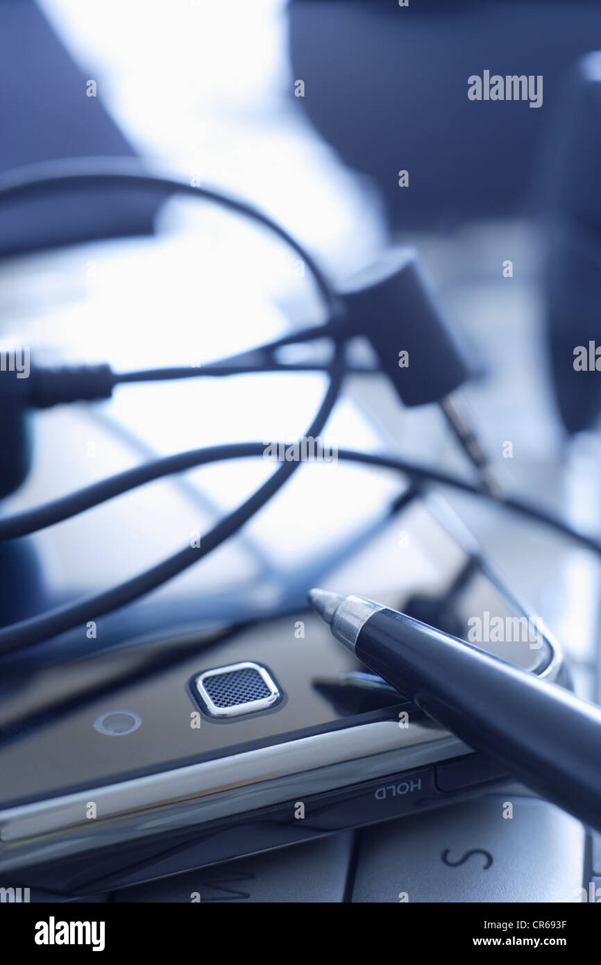 Cell phone on keyboard with headset in office, close up Stock Photo - Alamy