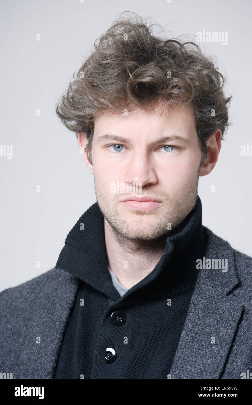 Man with grey coat against white background, close up Stock Photo - Alamy