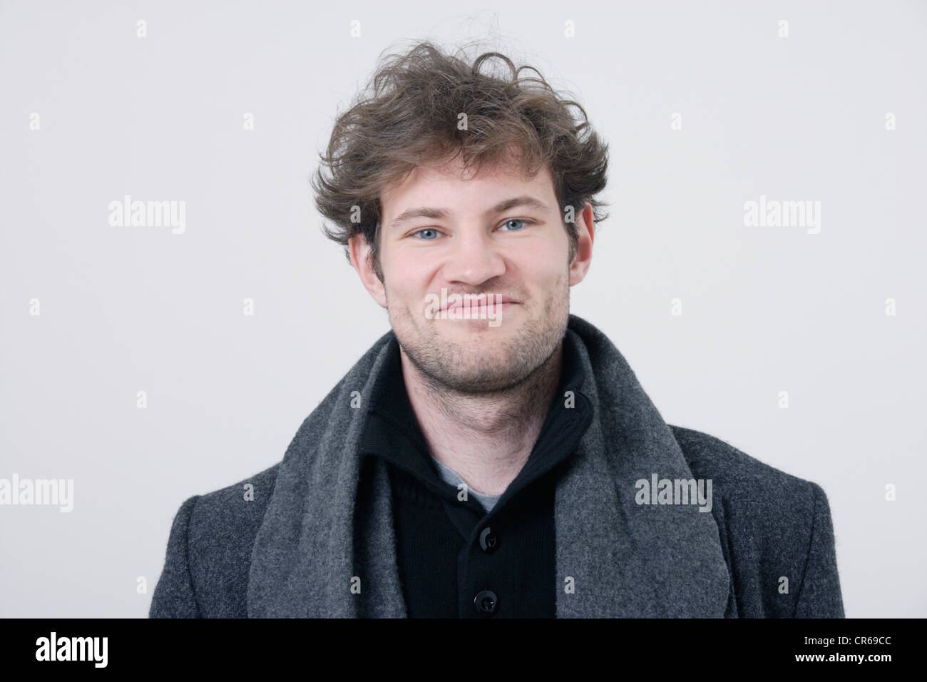 Man with grey coat against white background, smiling, close up Stock ...