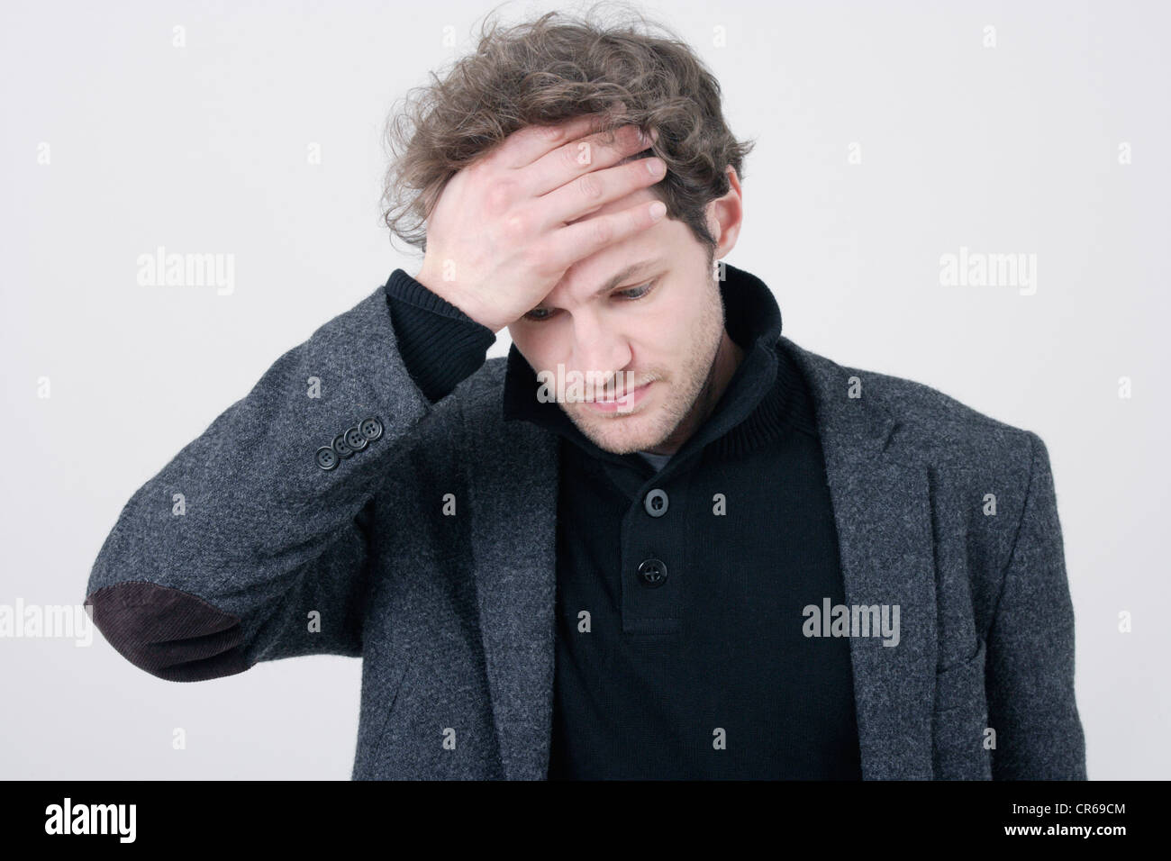Man with head in hand against white background, close up Stock Photo ...