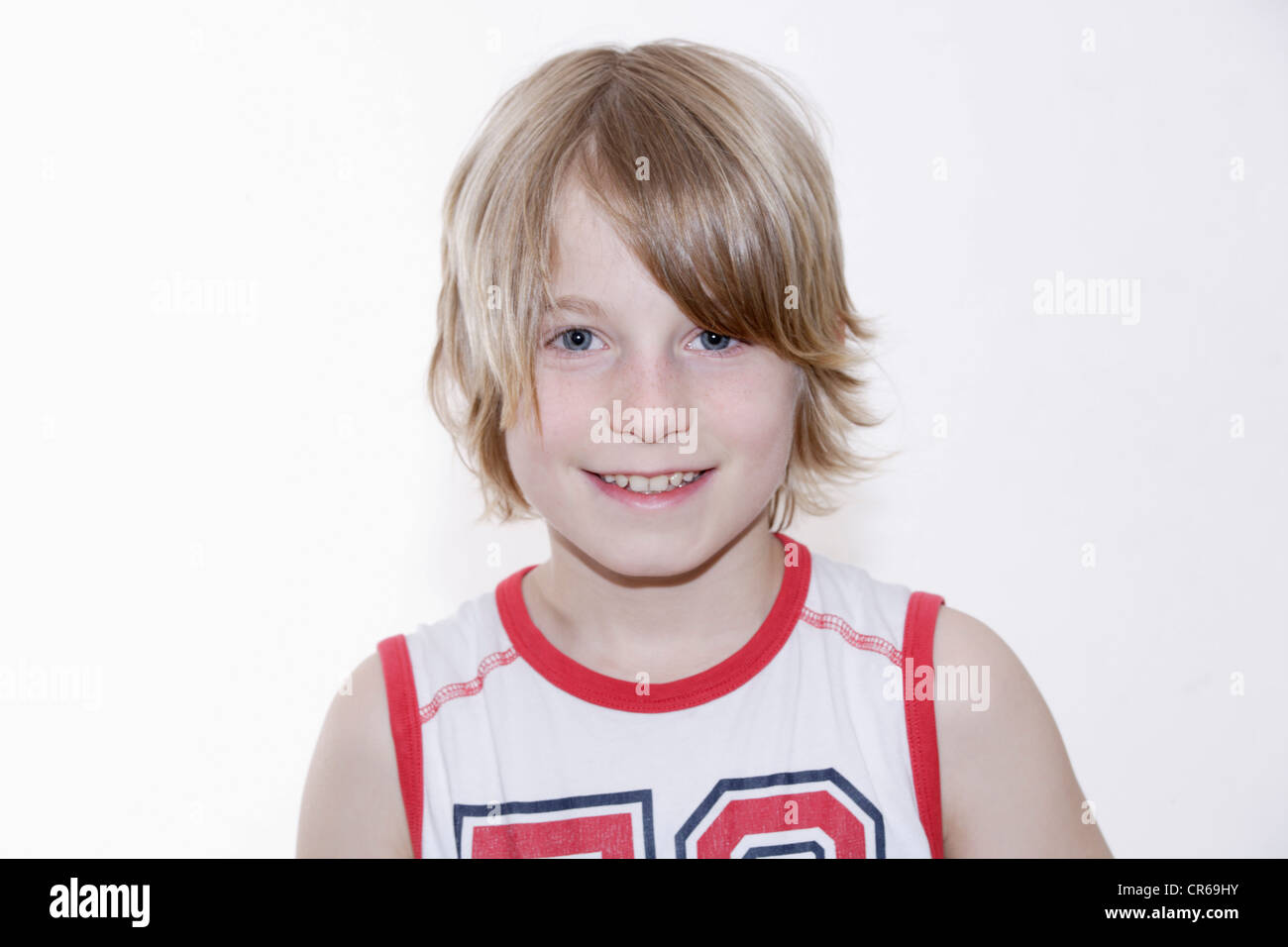 Boy smiling against white background, portrait Stock Photo - Alamy