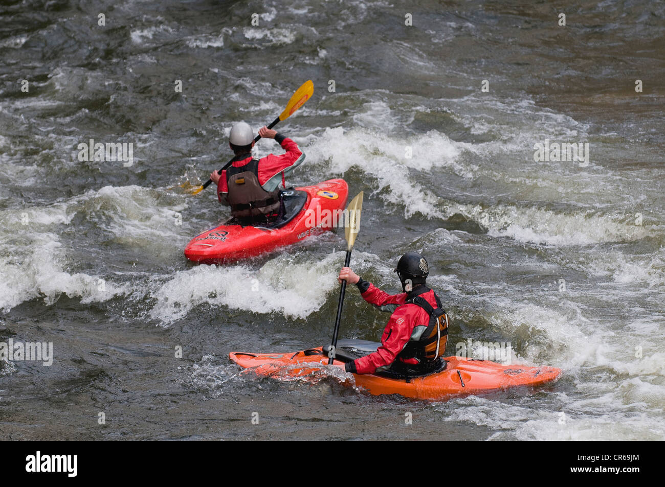 Two whitewater kayakers riding the rapids Stock Photo - Alamy