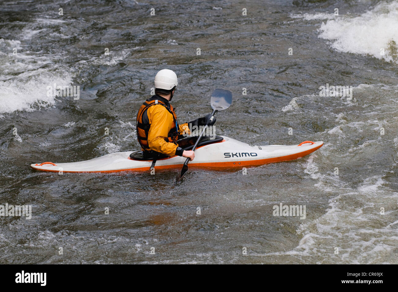 Whitewater kayaker maneuvering through the rapids Stock Photo - Alamy