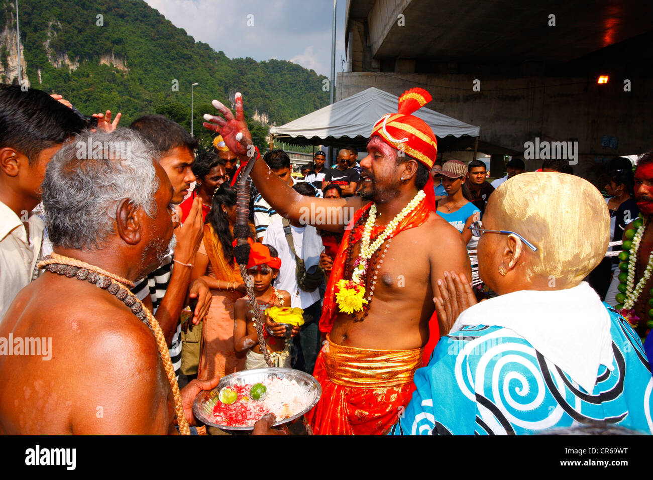 Holy man blessing believers, Hindu festival Thaipusam, Batu Caves ...