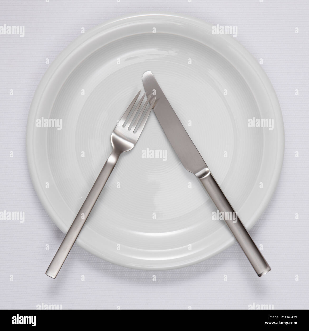 Plate with fork and knife Stock Photo - Alamy