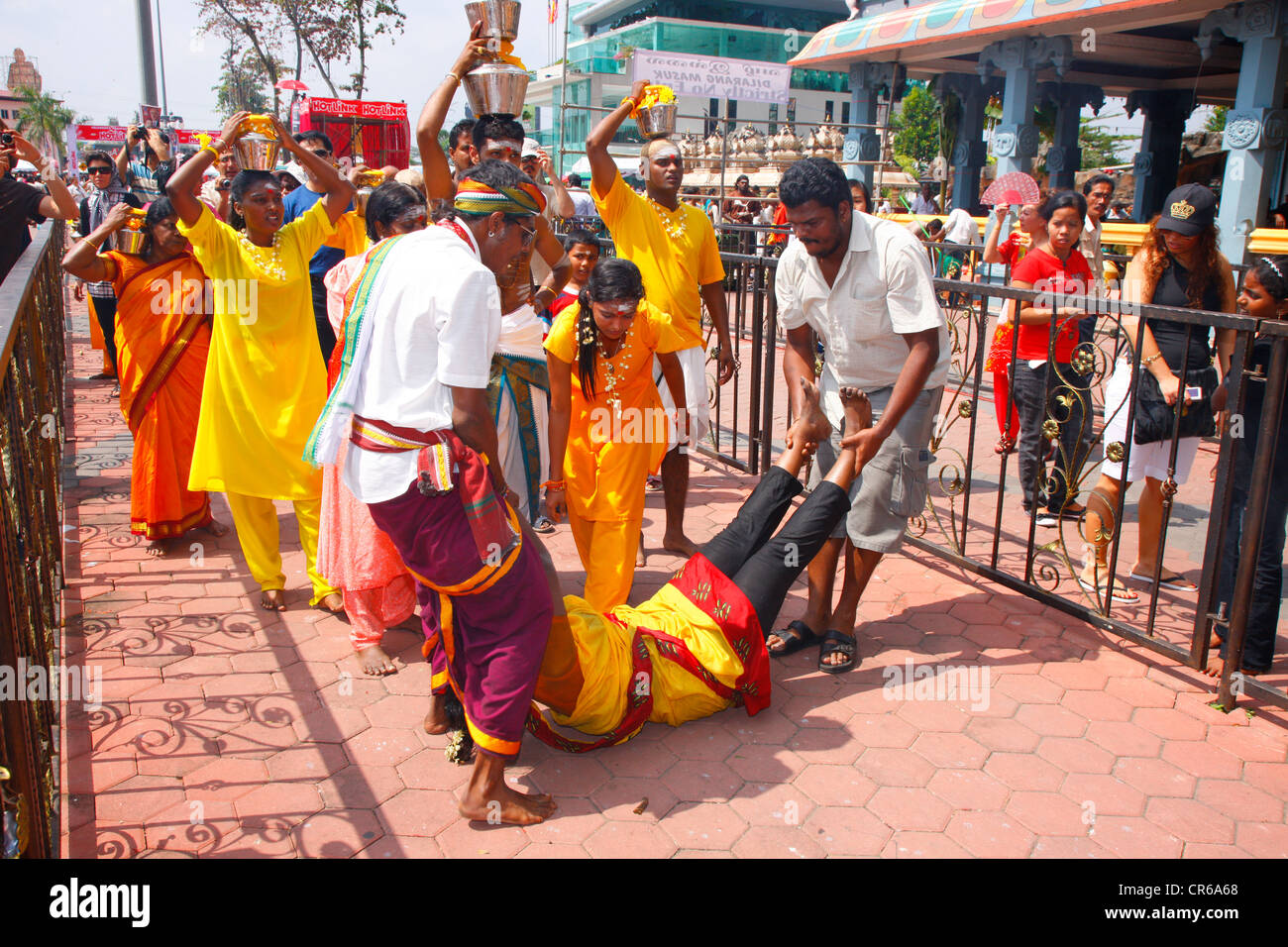 Pilgrim at the Hindu festival Thaipusam rolling on the ground to the ...