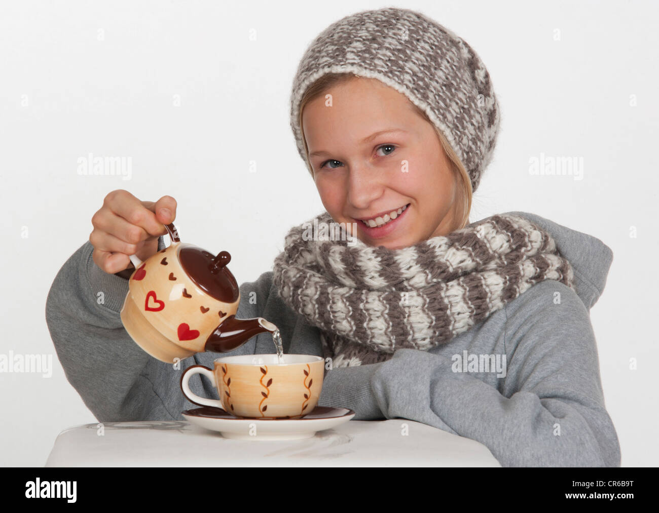 Teenage girl with tea cup, smiling, portrait Stock Photo - Alamy