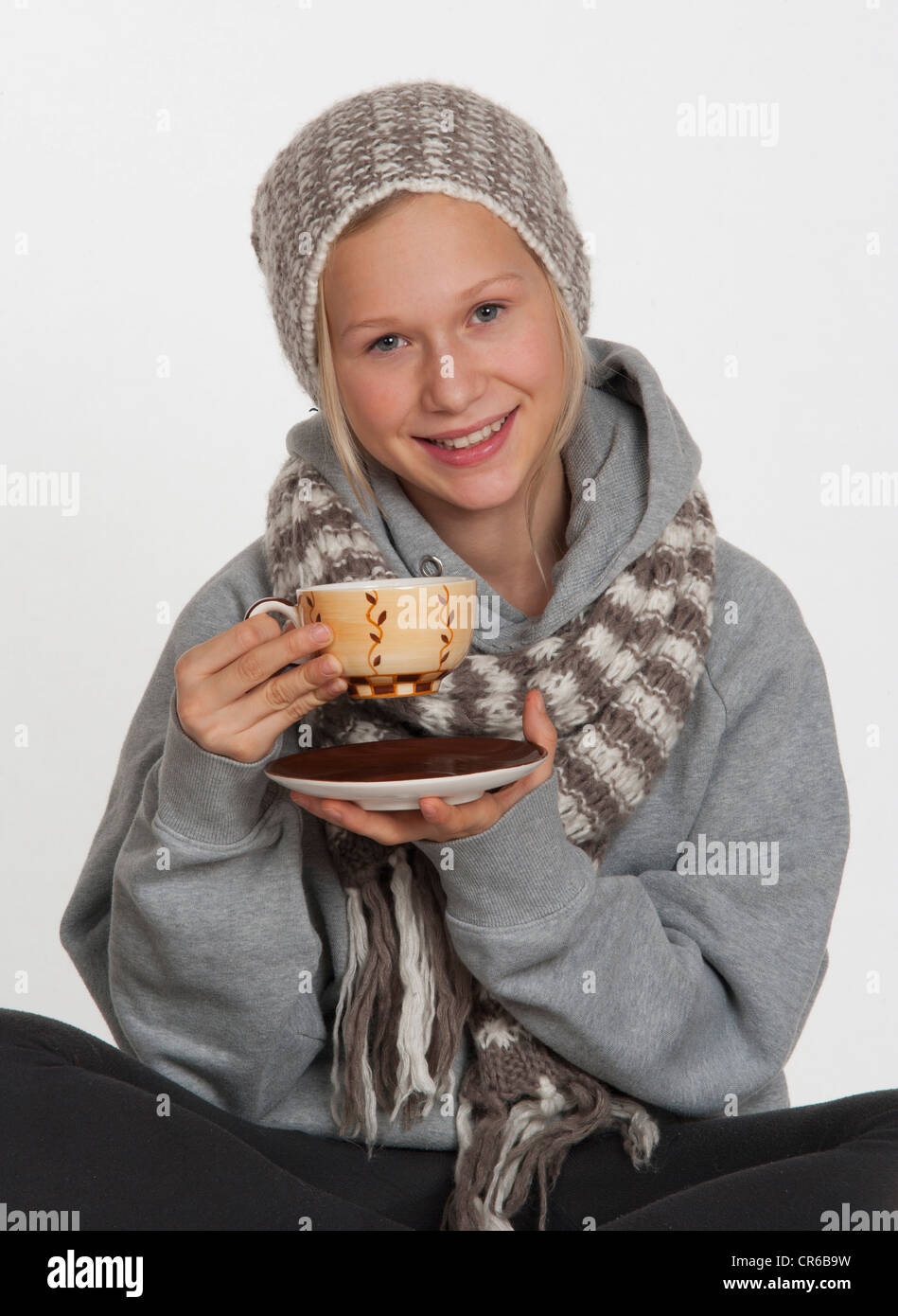 Teenage girl with tea cup, smiling, portrait Stock Photo - Alamy
