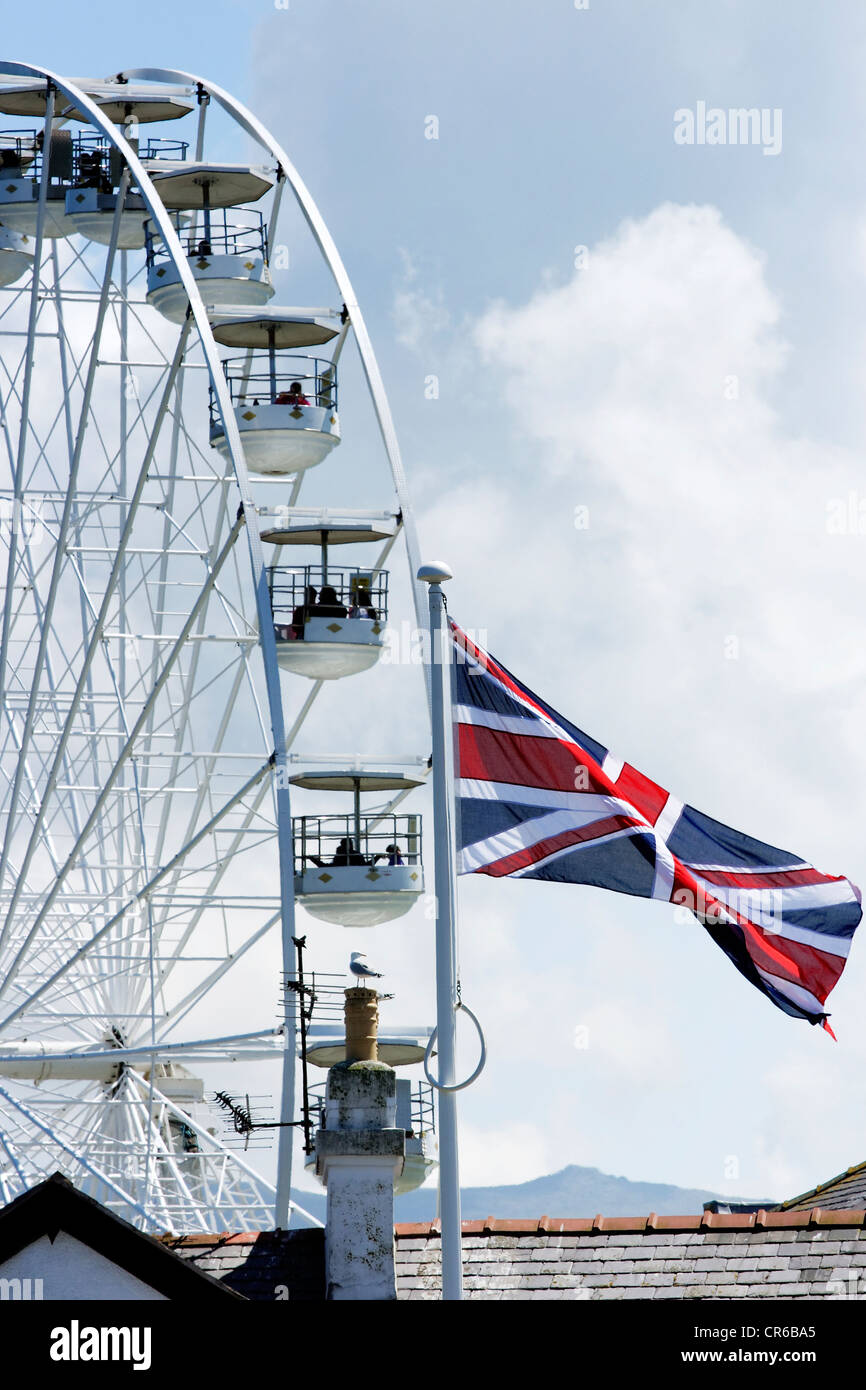 A fairground Ferris Wheel with a Union Flag in the foreground Stock ...
