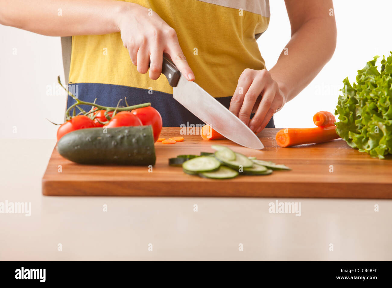 Young woman cutting vegetables Stock Photo - Alamy