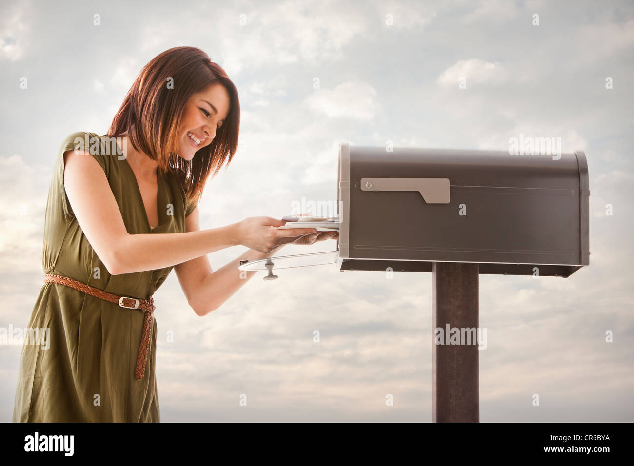 Young woman at mailbox Stock Photo - Alamy