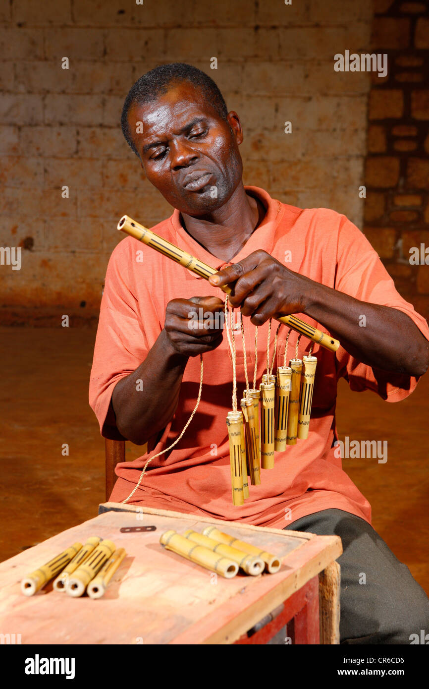 Man manufacturing wind chimes made of bamboo, Bafut, Cameroon, Africa ...