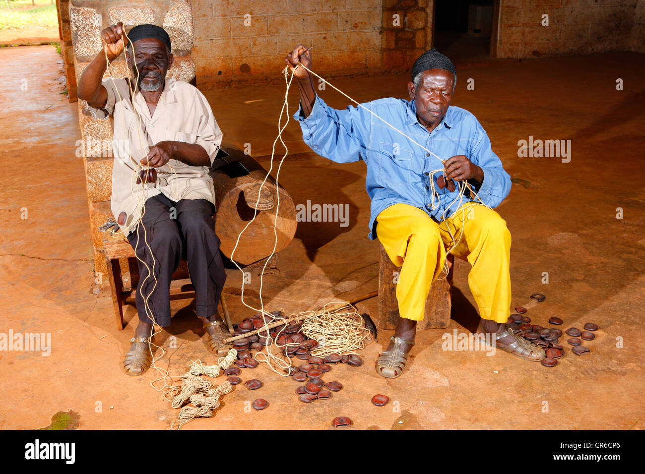 Men making traditional foot and hand rattles, Juju Rattles from Uyot ...