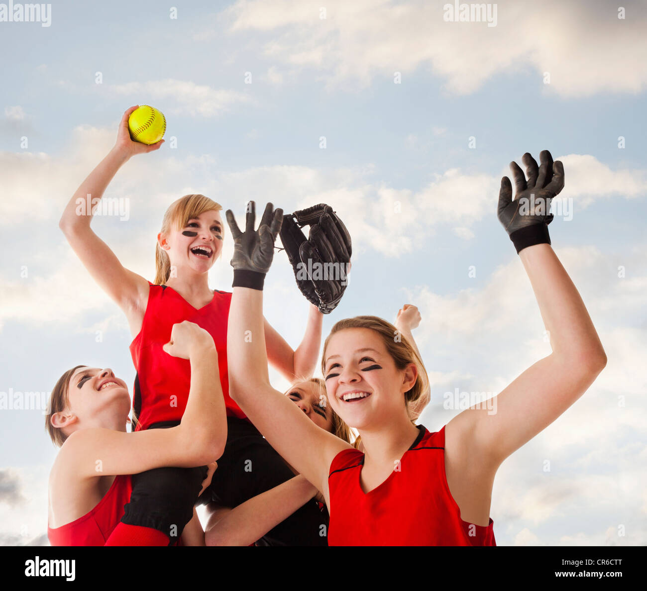 Girls (12-13) celebrating during playing softball Stock Photo - Alamy