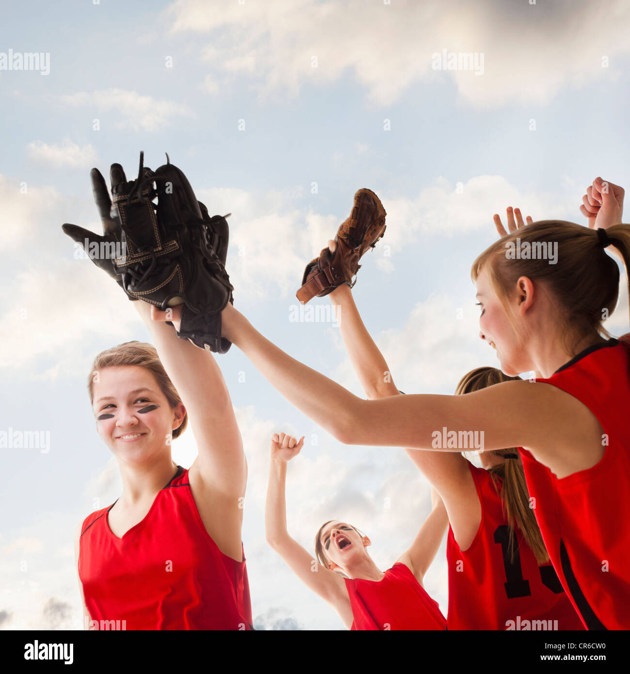 Girls (12-13) celebrating during playing softball Stock Photo - Alamy