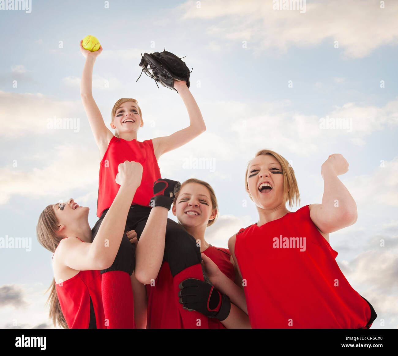 Girls (12-13) celebrating during playing softball Stock Photo - Alamy