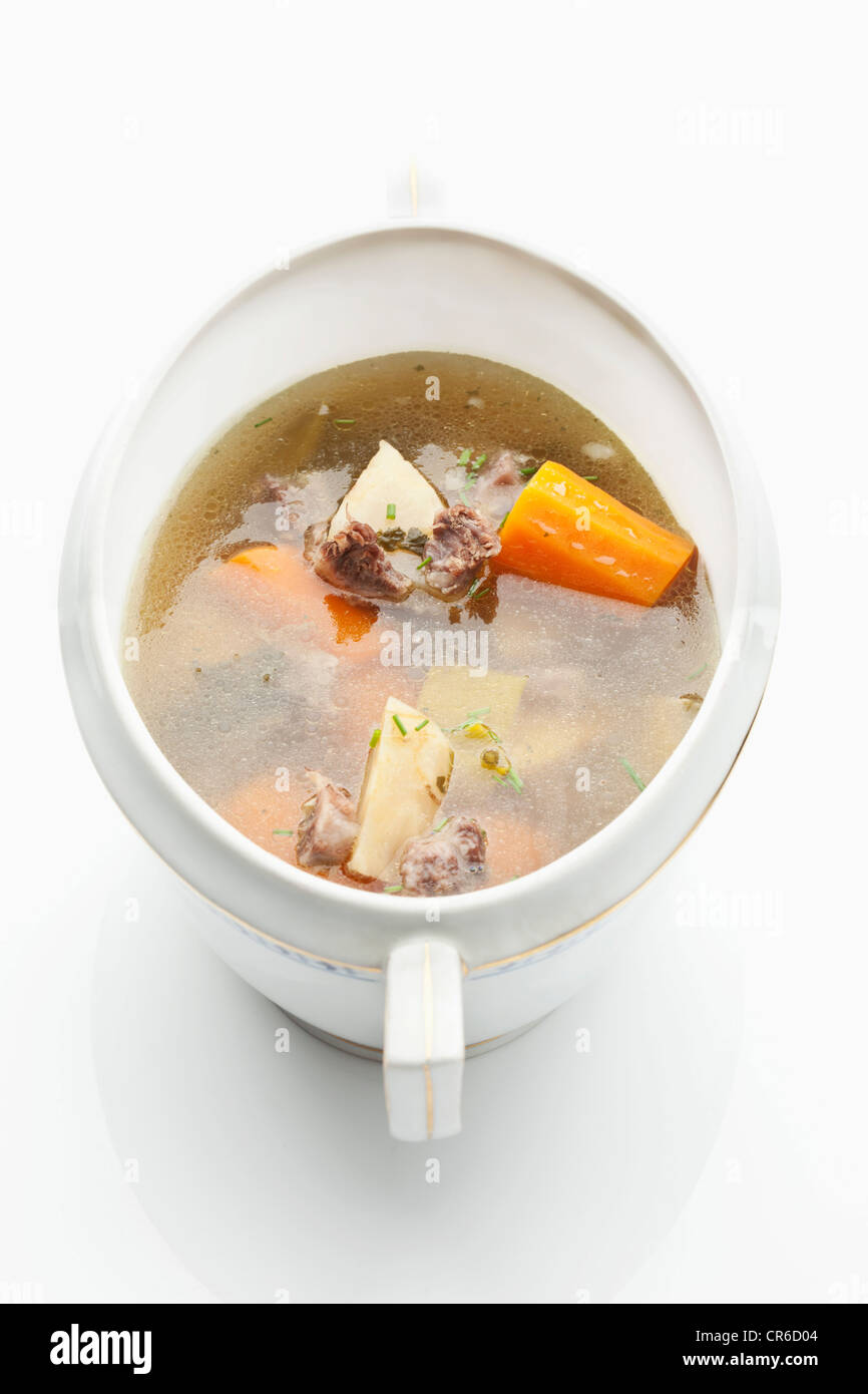 Beef broth in stew pot on white background Stock Photo - Alamy