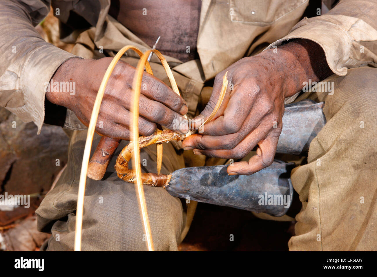 Musical instrument made of scrap metal is wrapped with plant fibers ...