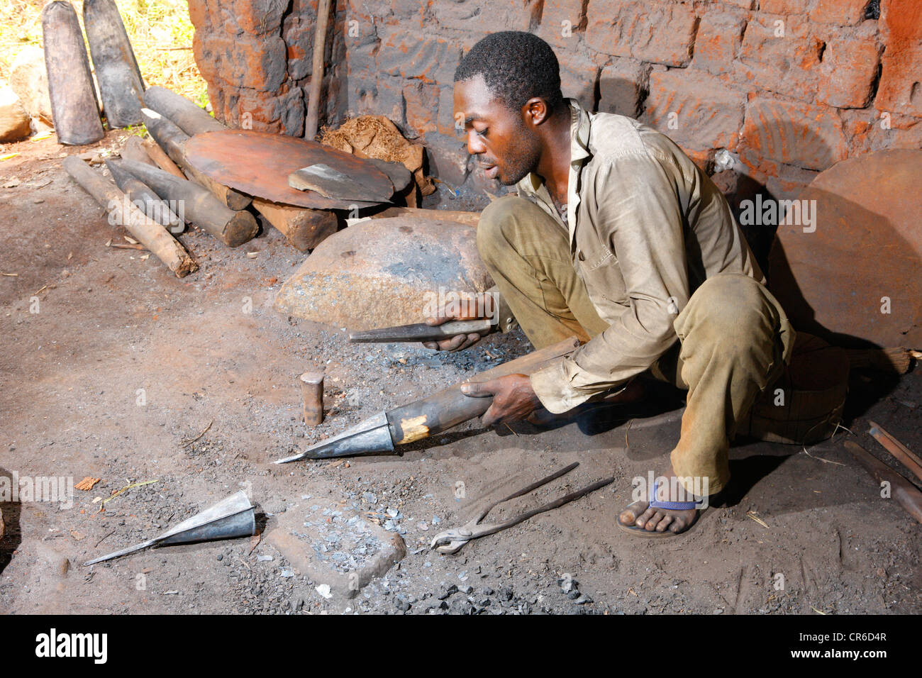Smith making a musical instrument from scrap metal, Babungo, Cameroon ...