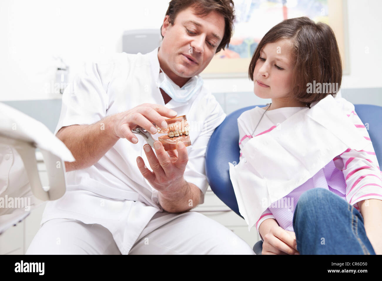 Germany, Bavaria, Patient and doctor looking at dentures Stock Photo ...