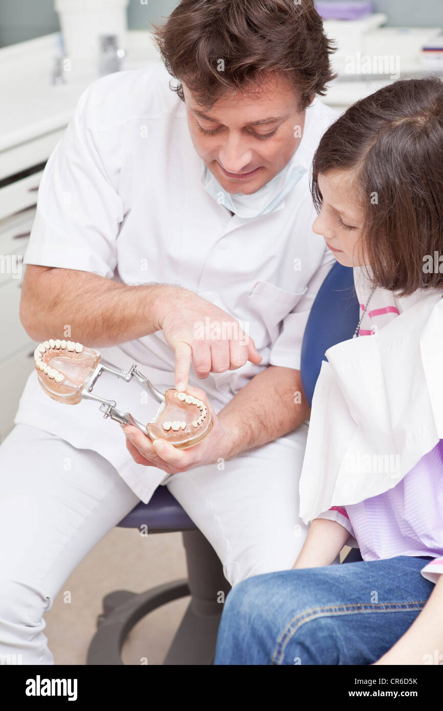 Germany, Bavaria, Patient and doctor looking at dentures Stock Photo ...