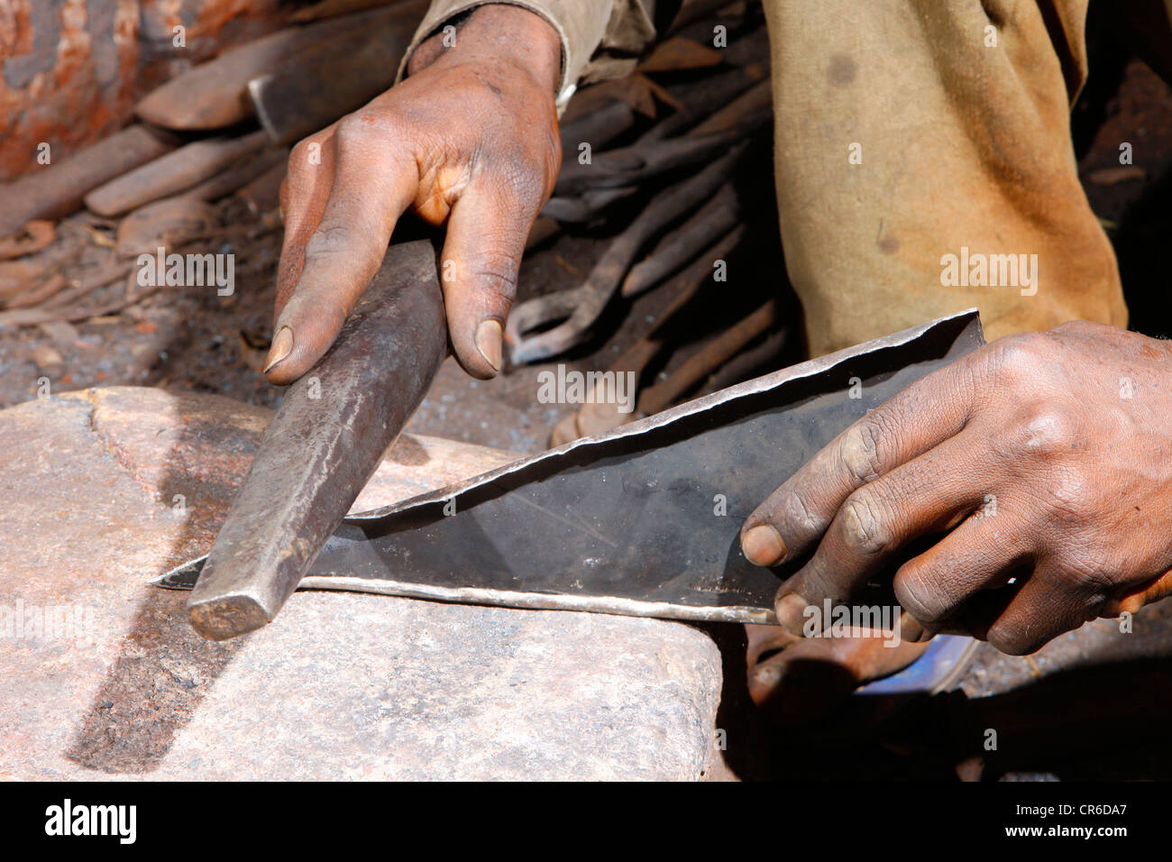 Smith making a musical instrument from scrap metal, Babungo, Cameroon ...