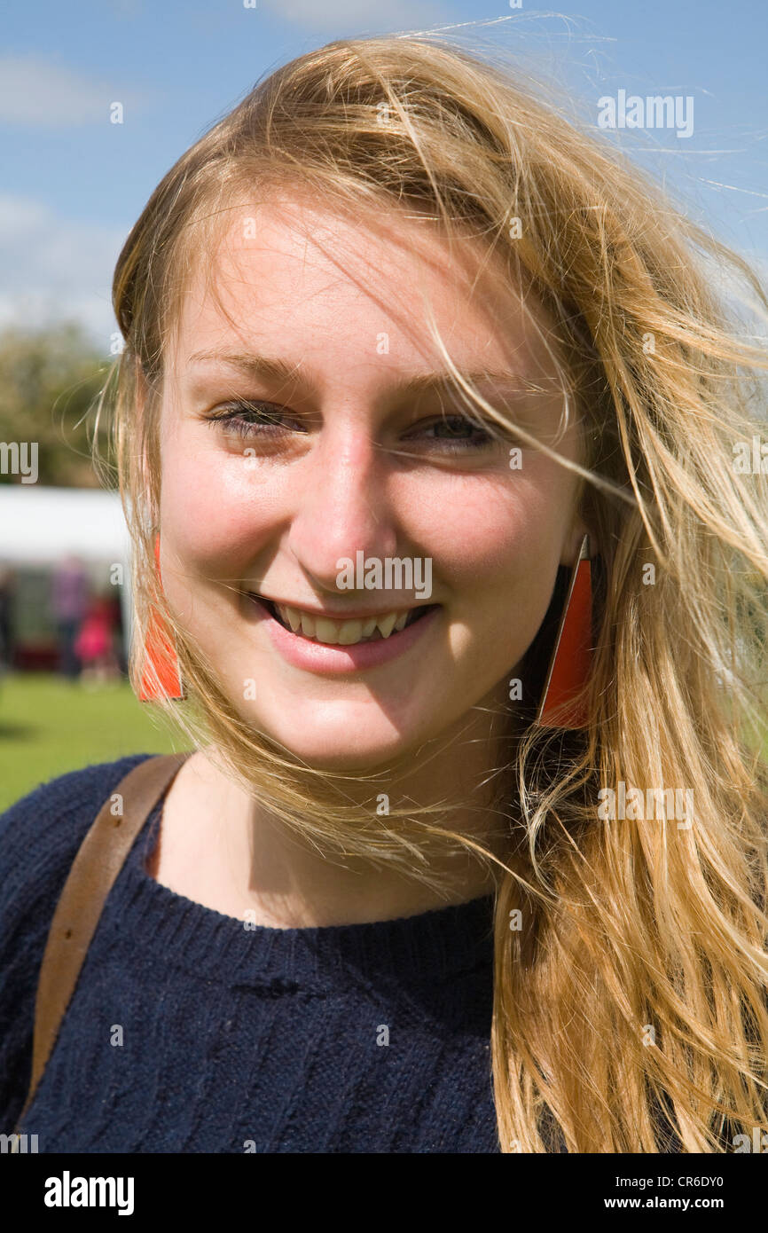 Portrait young woman head face shoulders wind blowing hair over face ...