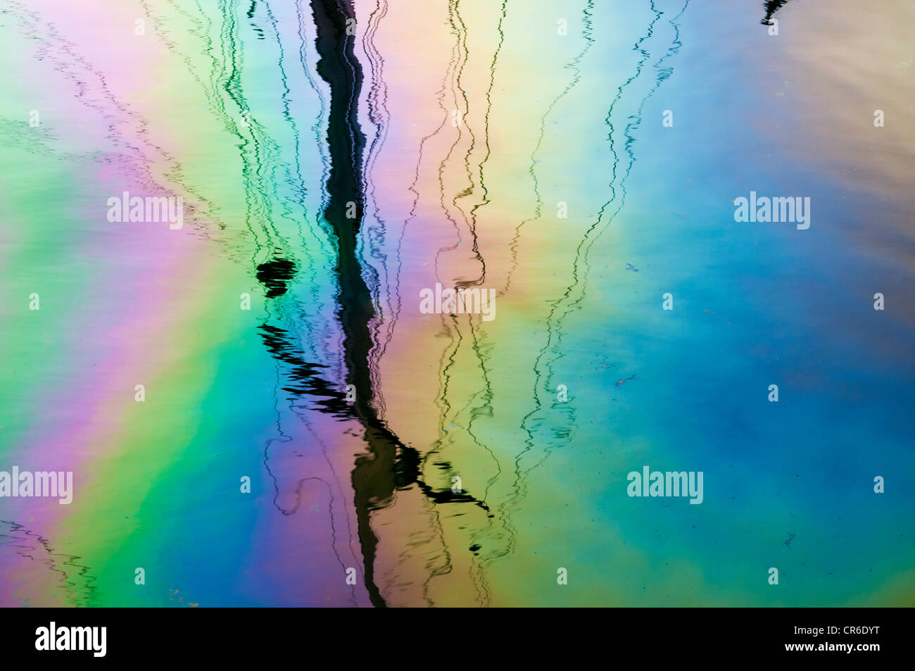 Surface of water with the colorful sheen from a fuel leak and the ...
