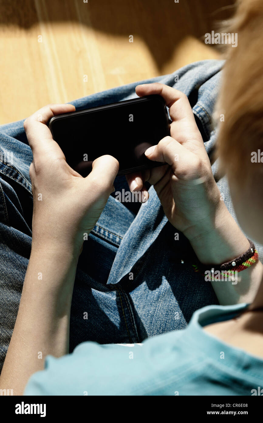 Germany, Hamburg, Boy playing with an electronic device Stock Photo - Alamy