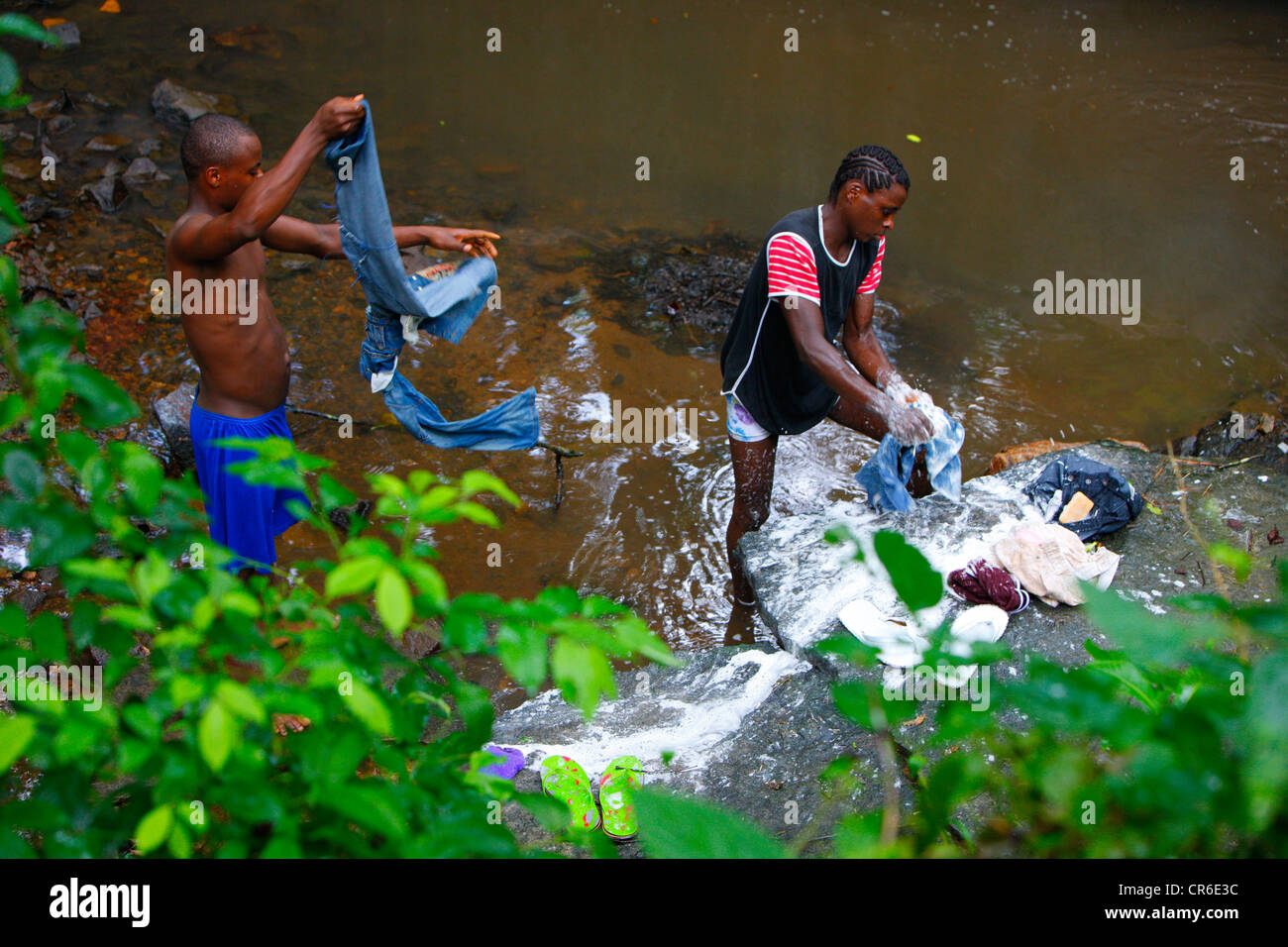 Young men washing their jeans in a stream, Bamenda, Cameroon, Africa ...