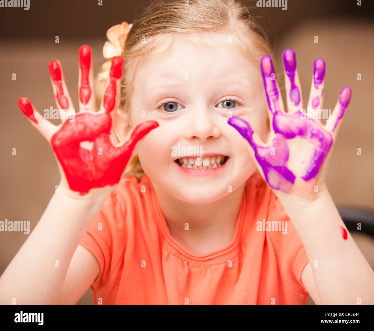 Girl (4-5) with paint covered hands Stock Photo - Alamy