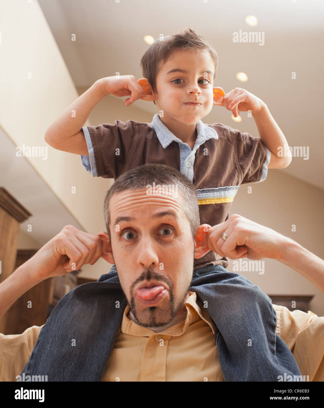 Father and son (6-7) pulling funny faces Stock Photo - Alamy