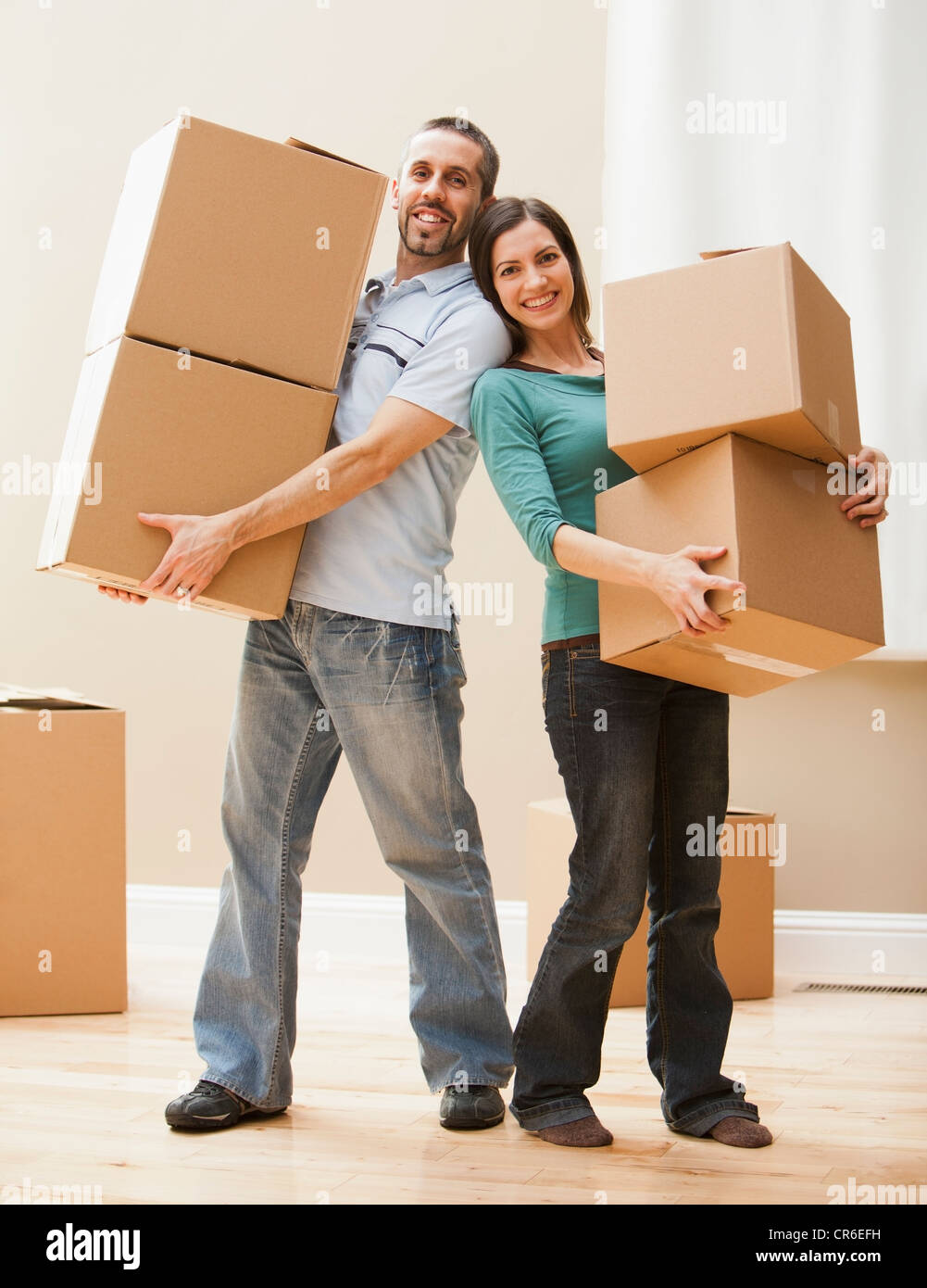 Mid adult couple carrying cardboard boxes Stock Photo - Alamy