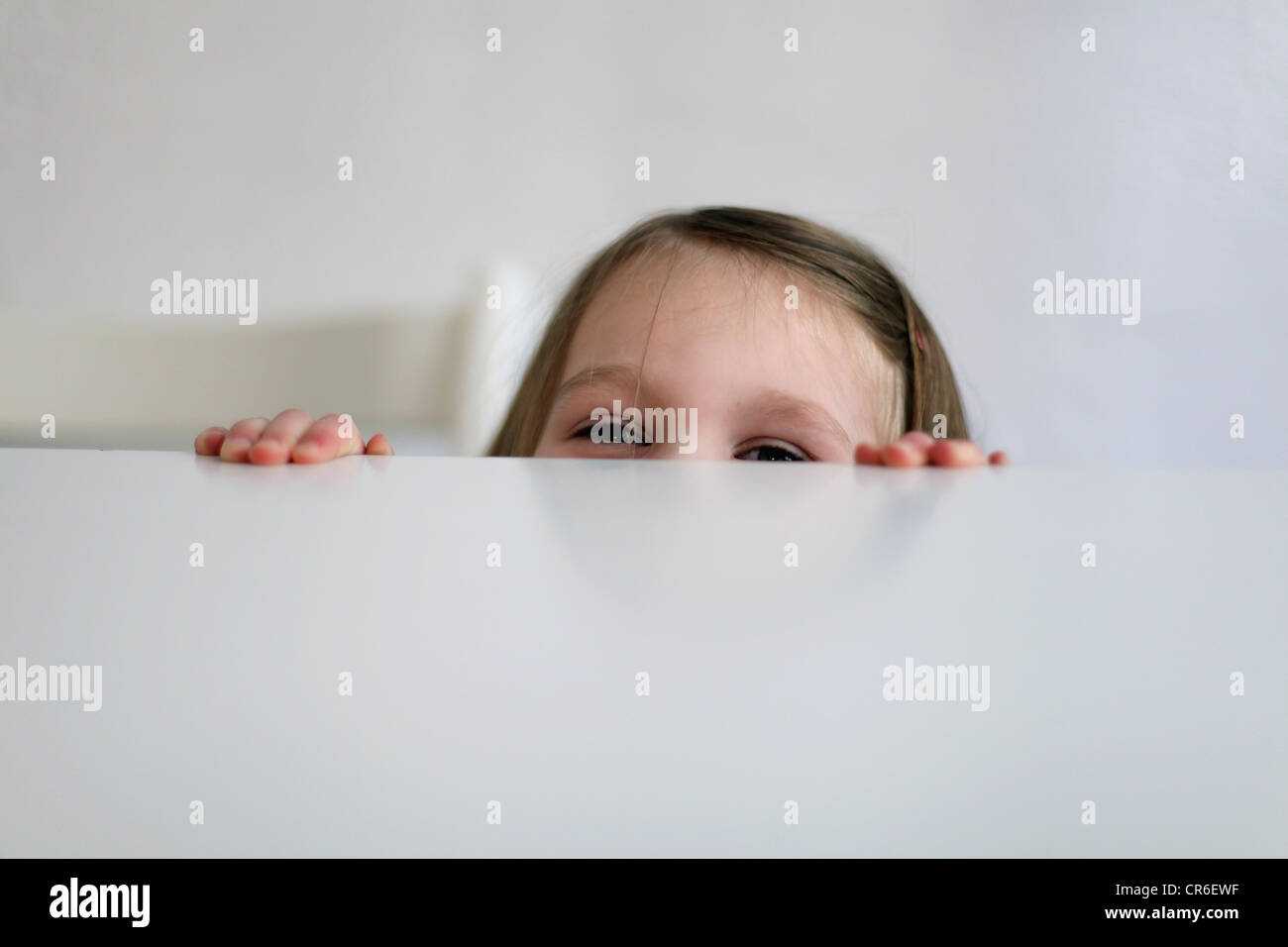 Girl hiding at table hi-res stock photography and images - Alamy