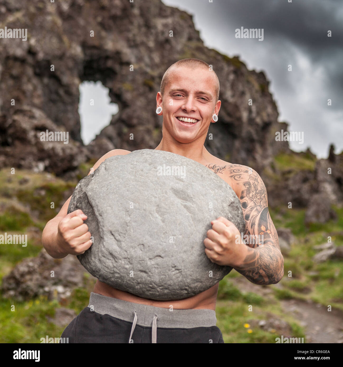 Strong man holding heavy stones, Djupalonssandur, Snaefellsnes ...