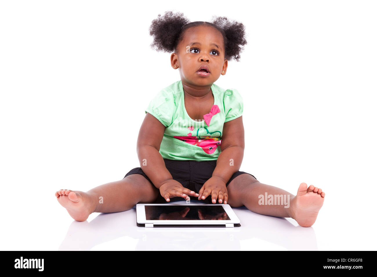 Little african american girl using a tablet pc, isolated on white ...