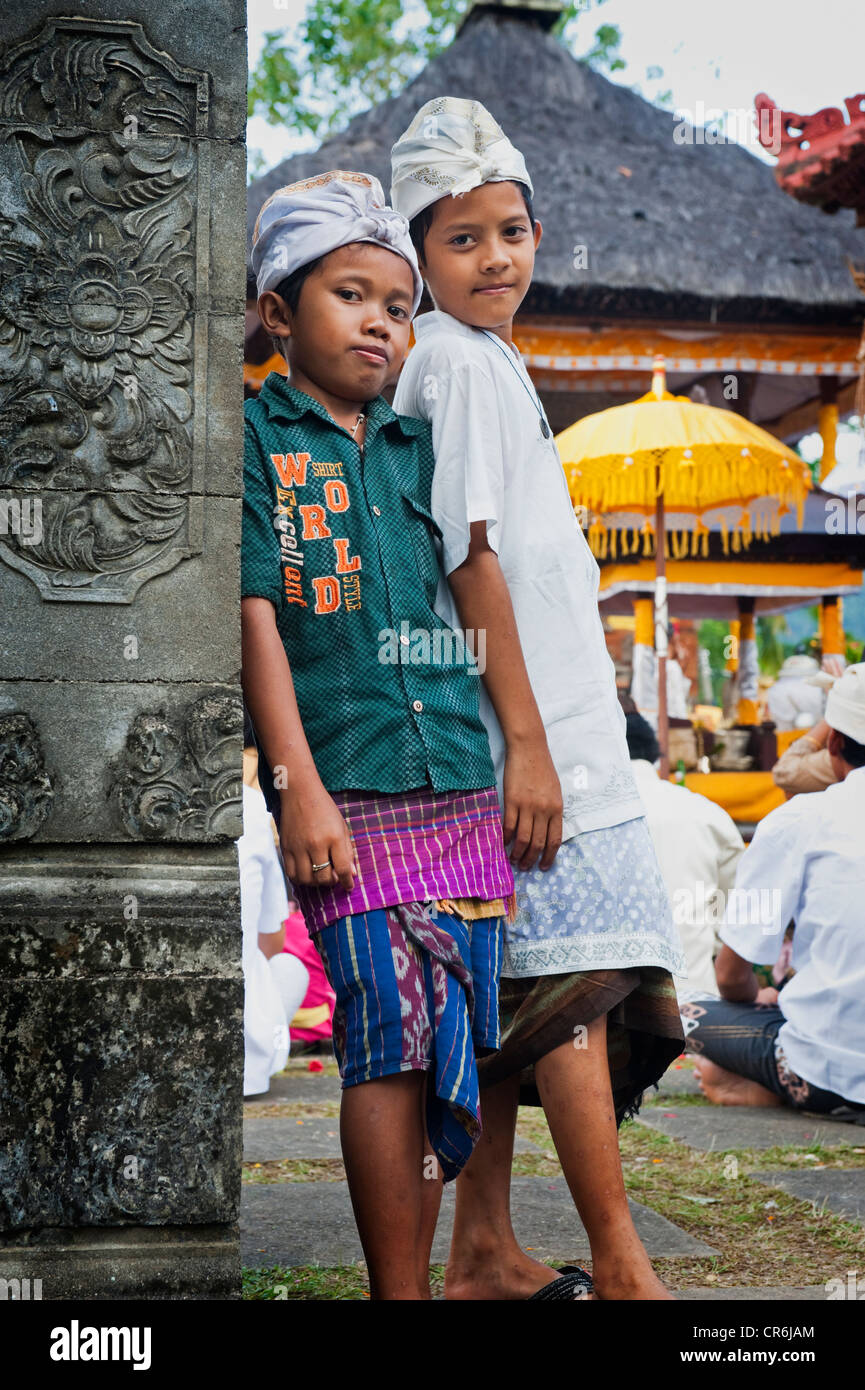 A couple of young Balinese boys pose in traditional dress for a photo ...