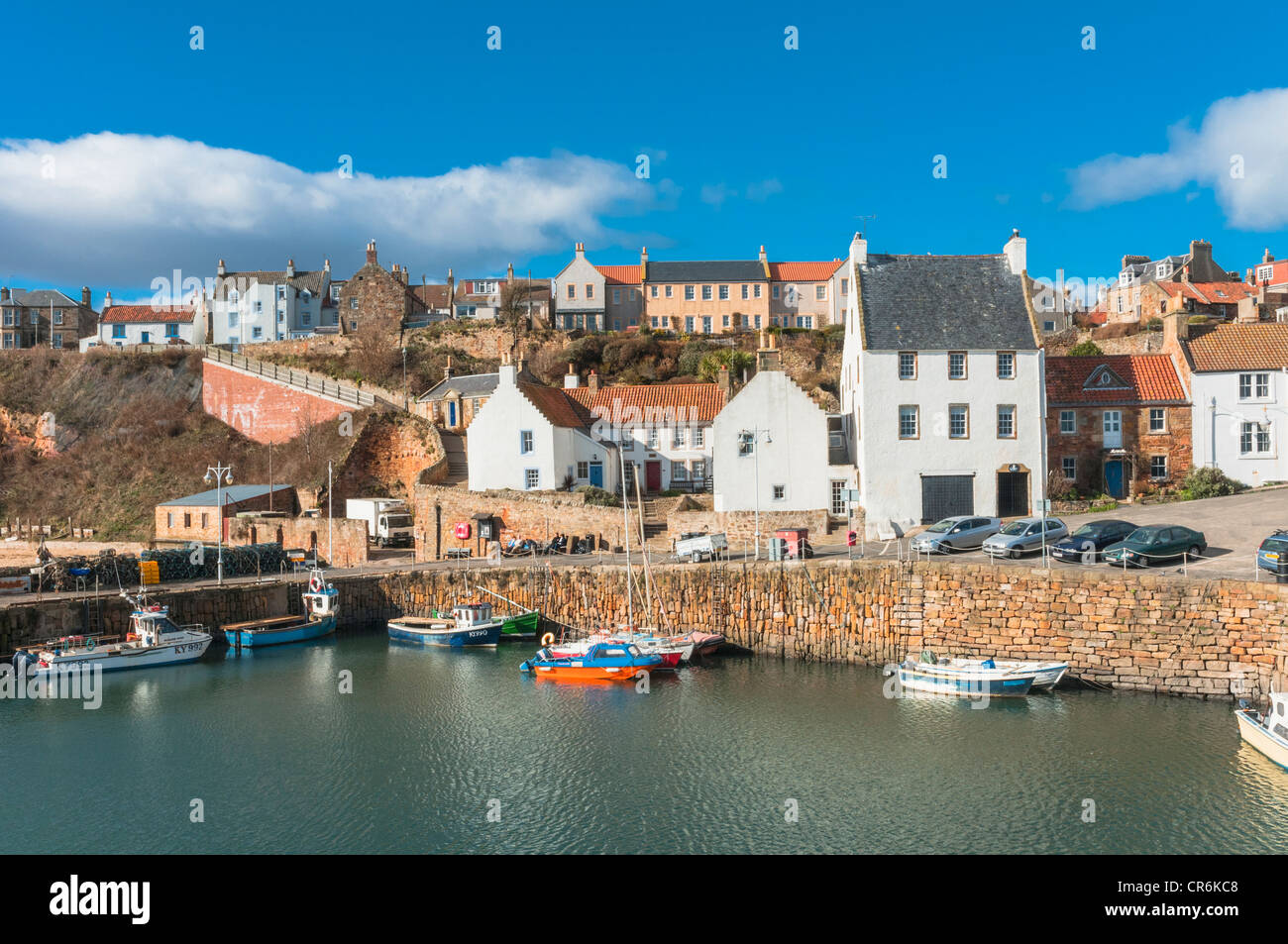 Fishing boats and boats Crail harbour Fife Scotland with old fishermen ...