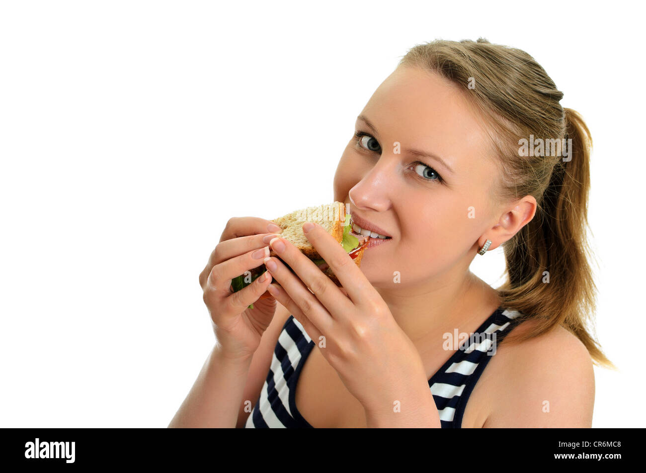 Attractive female eating sandwich, isolated on white Stock Photo - Alamy