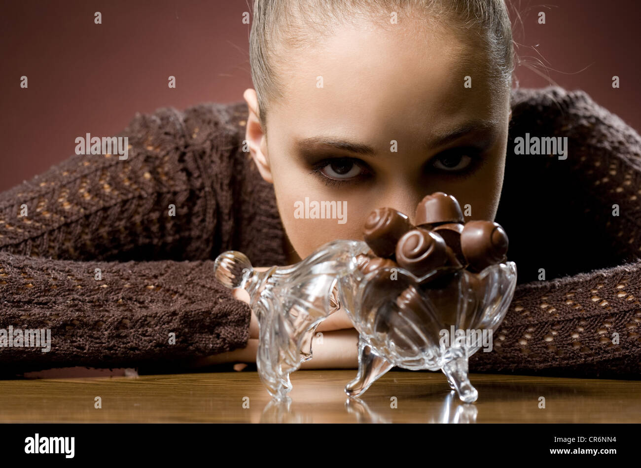Chocolate addiction, moody portrait of gorgeous brunette with chocolate ...